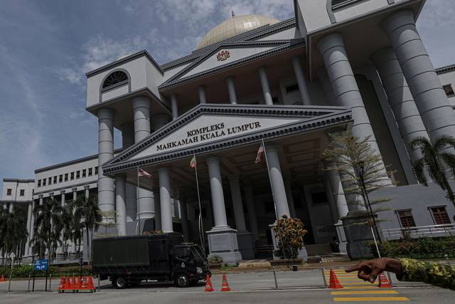 Two cops among four sentenced to 12 years jail, caning for RM1.1 ...